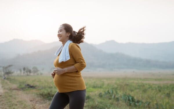Running While Pregnant: ACOG-Backed Trimester Guide + Red Flags