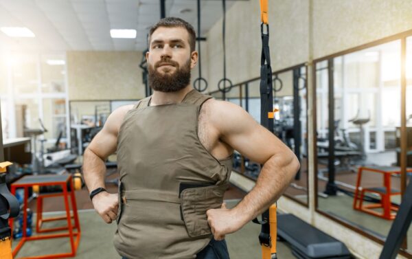 Running With Weights: Pros, Cons + How To Do So Safely