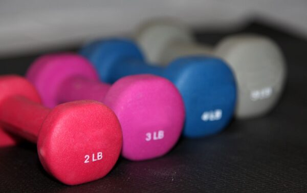 Running With Weights: Pros, Cons + How To Do So Safely