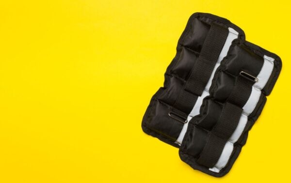 Running With Weights: Pros, Cons + How To Do So Safely