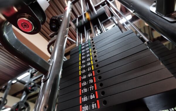 Free Weights Vs Machines: The Pros, Cons + Which Is Right For You?